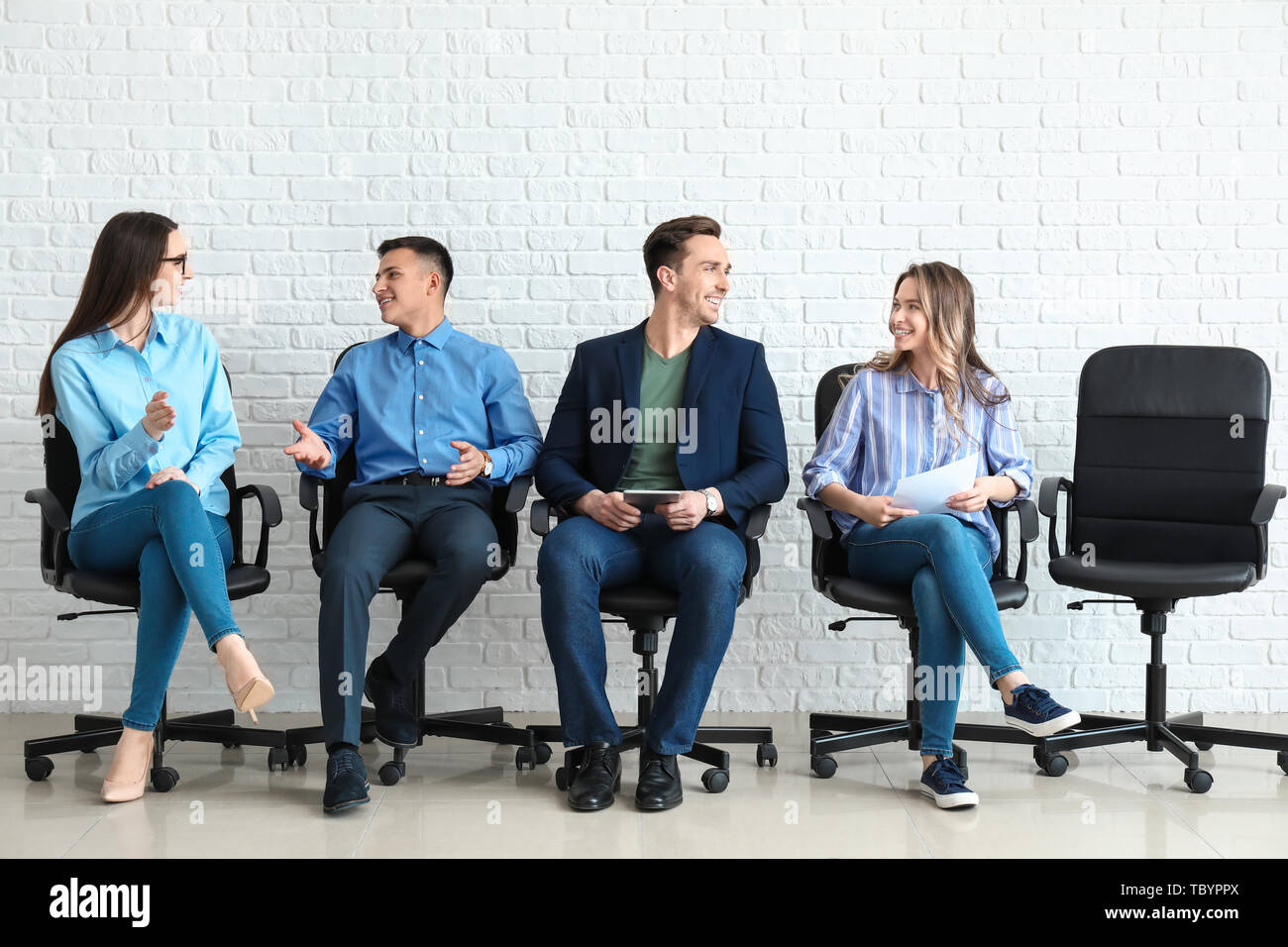 Young people waiting for job interview indoors Stock Photo - Alamy
