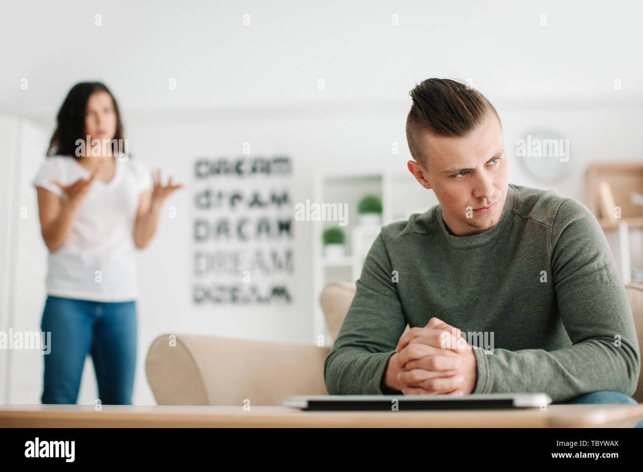 Young wife scolding her sad husband at home Stock Photo - Alamy