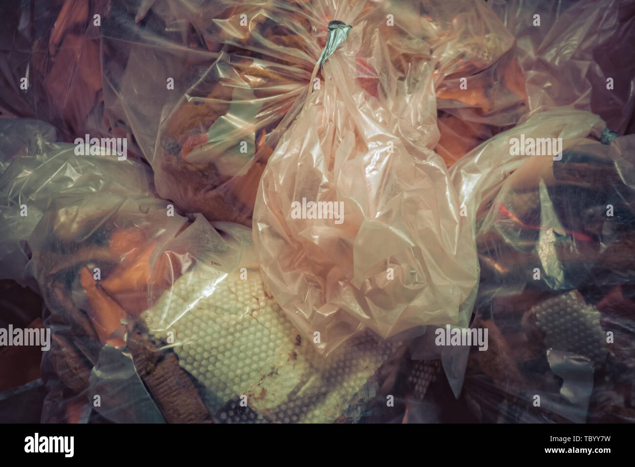 Lots of garbage in plastic bags thrown in a heap Stock Photo - Alamy