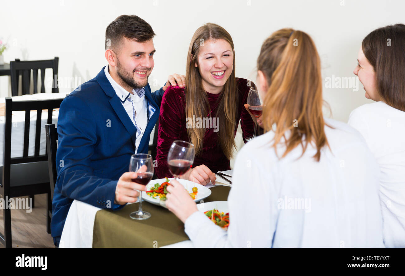 Gentleman with elegant women are having dinner in luxury restaurante ...