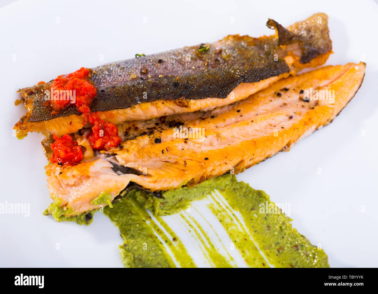Healthy seafood meal - roasted trout fish fillet with sauces Stock ...