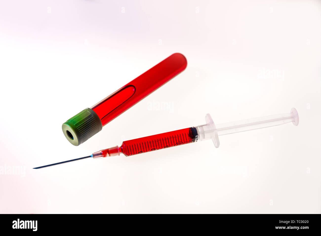Syringe and test tube with blood isolated on white background Stock ...