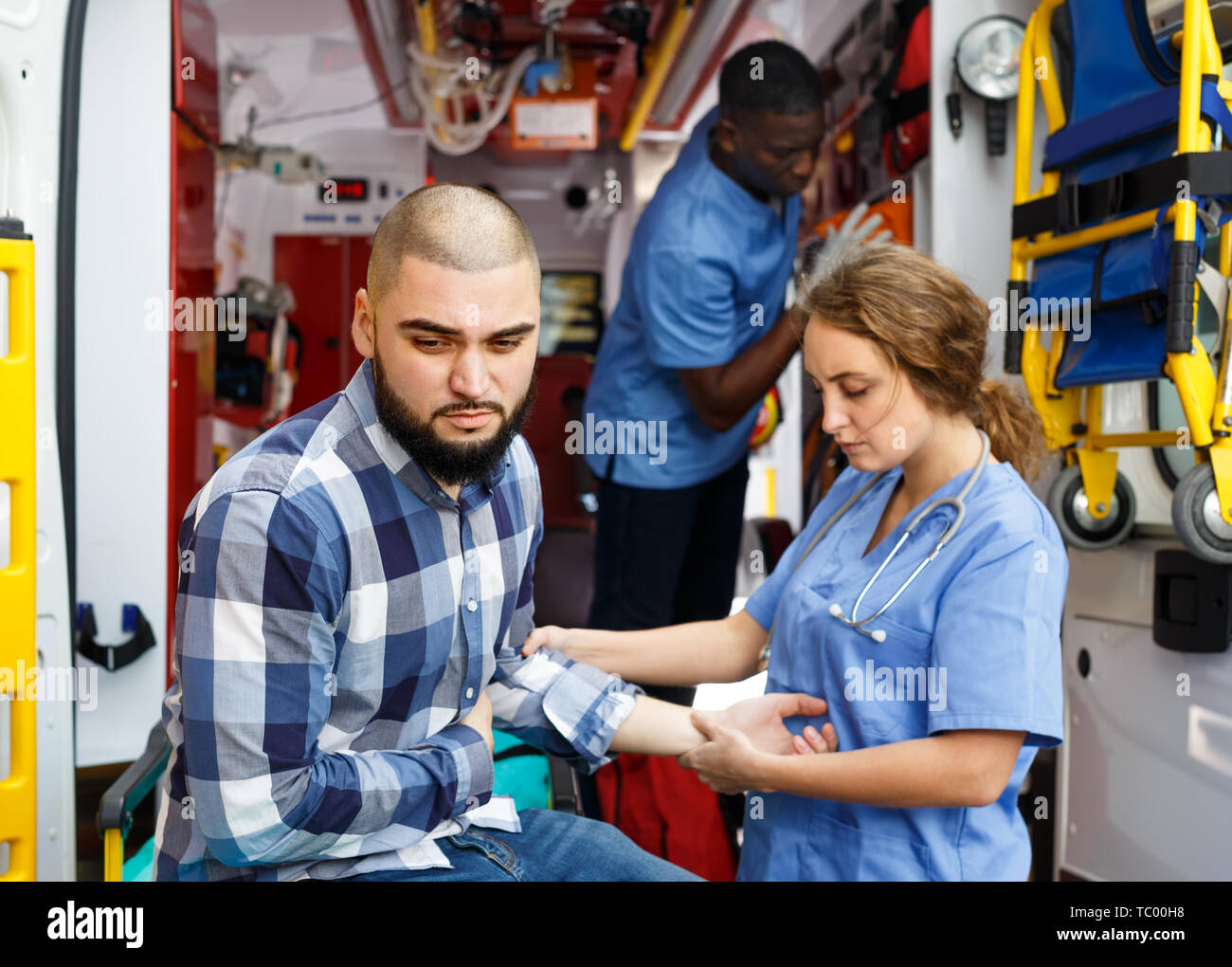 professional ambulance team providing medical care to male patient in ...