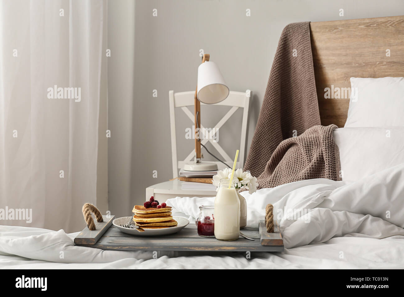 Board with tasty breakfast on bed Stock Photo - Alamy