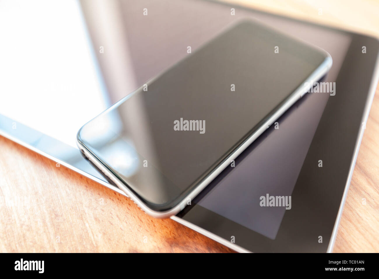 digital tablet and smart phone on wooden table Stock Photo - Alamy