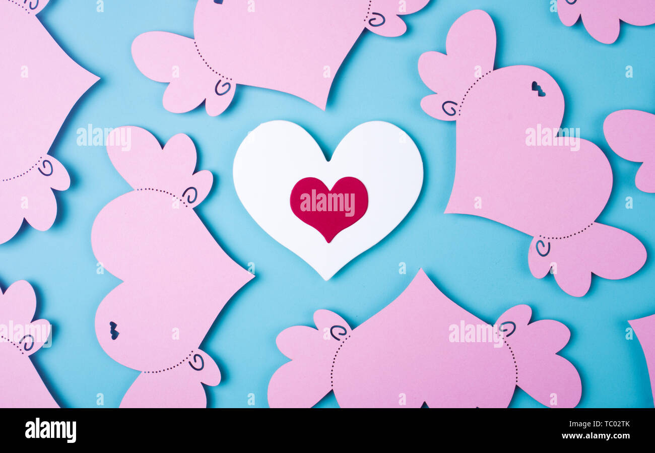 Love heart shape of angel image on blue background Stock Photo - Alamy
