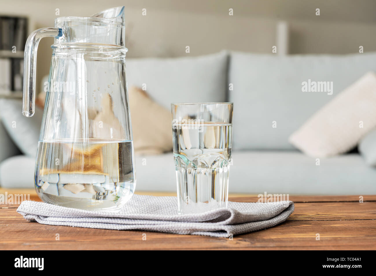 Glass and jug of fresh water on table Stock Photo - Alamy