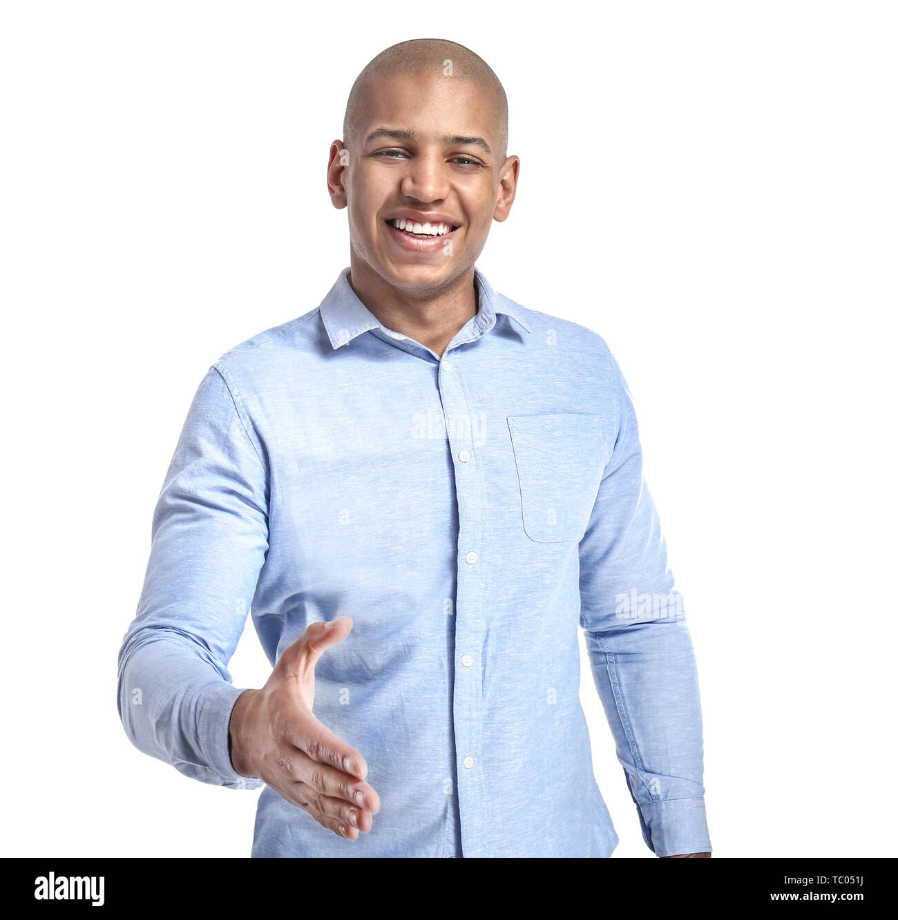 Handsome African-American man extending hand for handshake on white ...