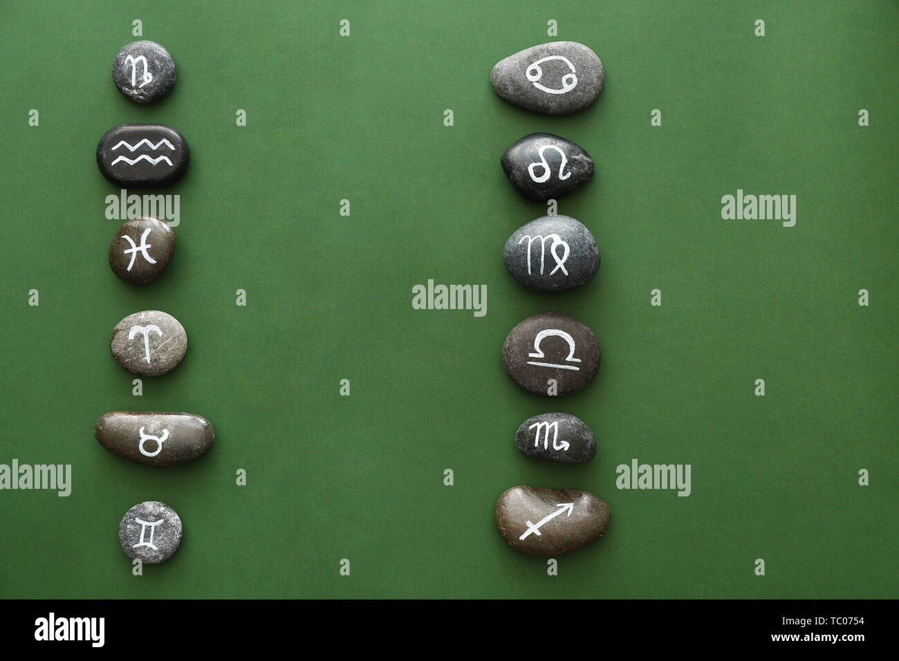 Stones with painted Zodiac signs on color background Stock Photo - Alamy