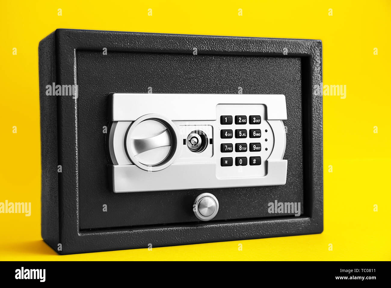 Modern safe on color background Stock Photo - Alamy