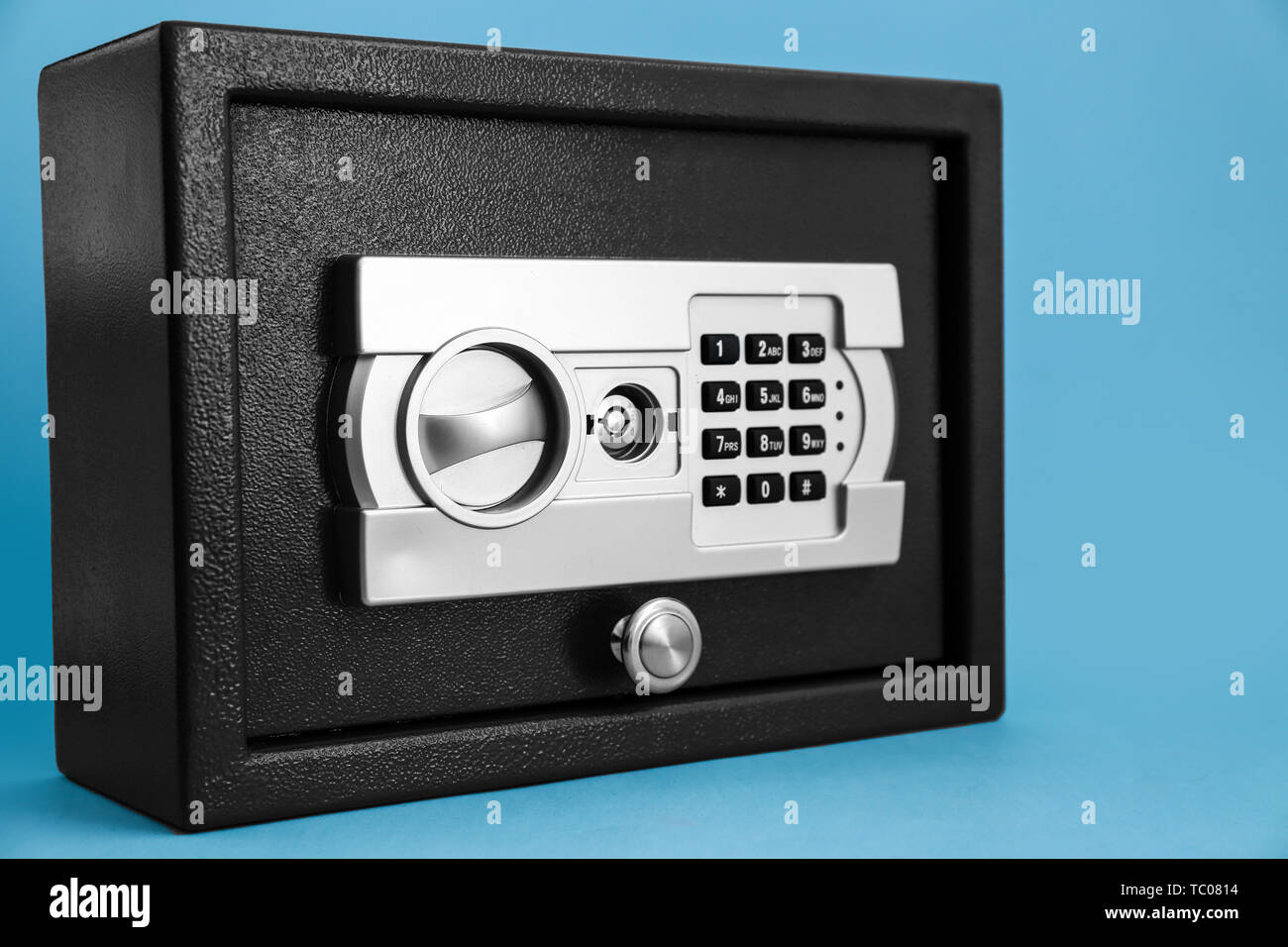 Modern safe on color background Stock Photo - Alamy