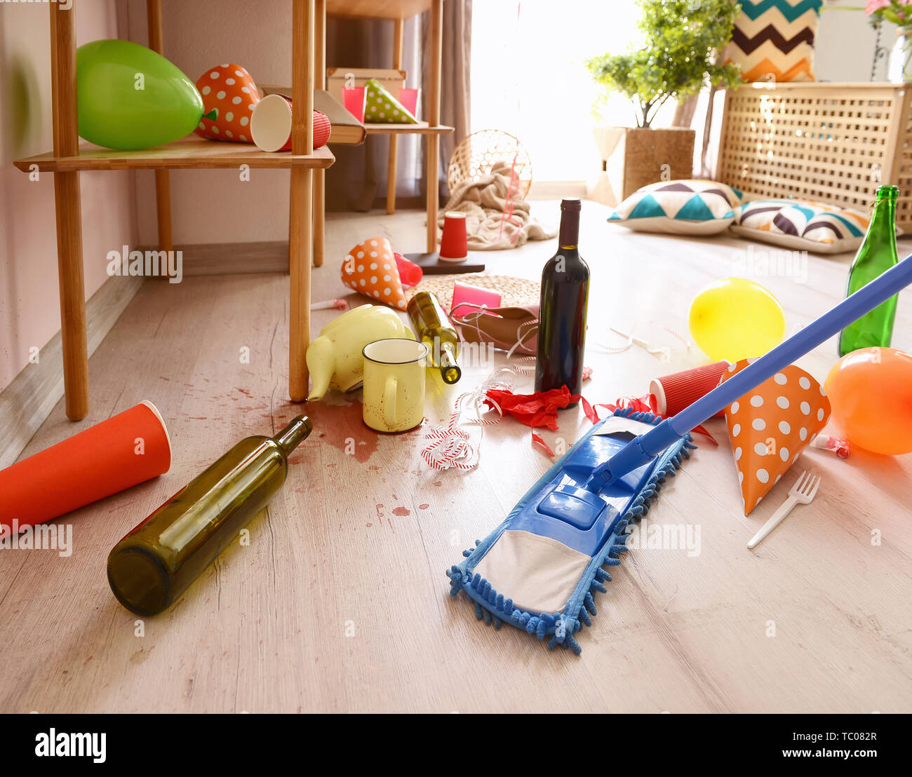 Cleaning of room in terrible mess after party Stock Photo - Alamy