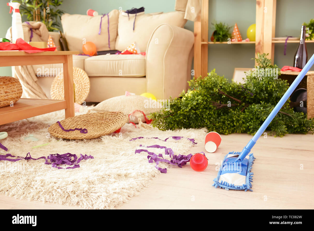 Cleaning of room in terrible mess after party Stock Photo - Alamy