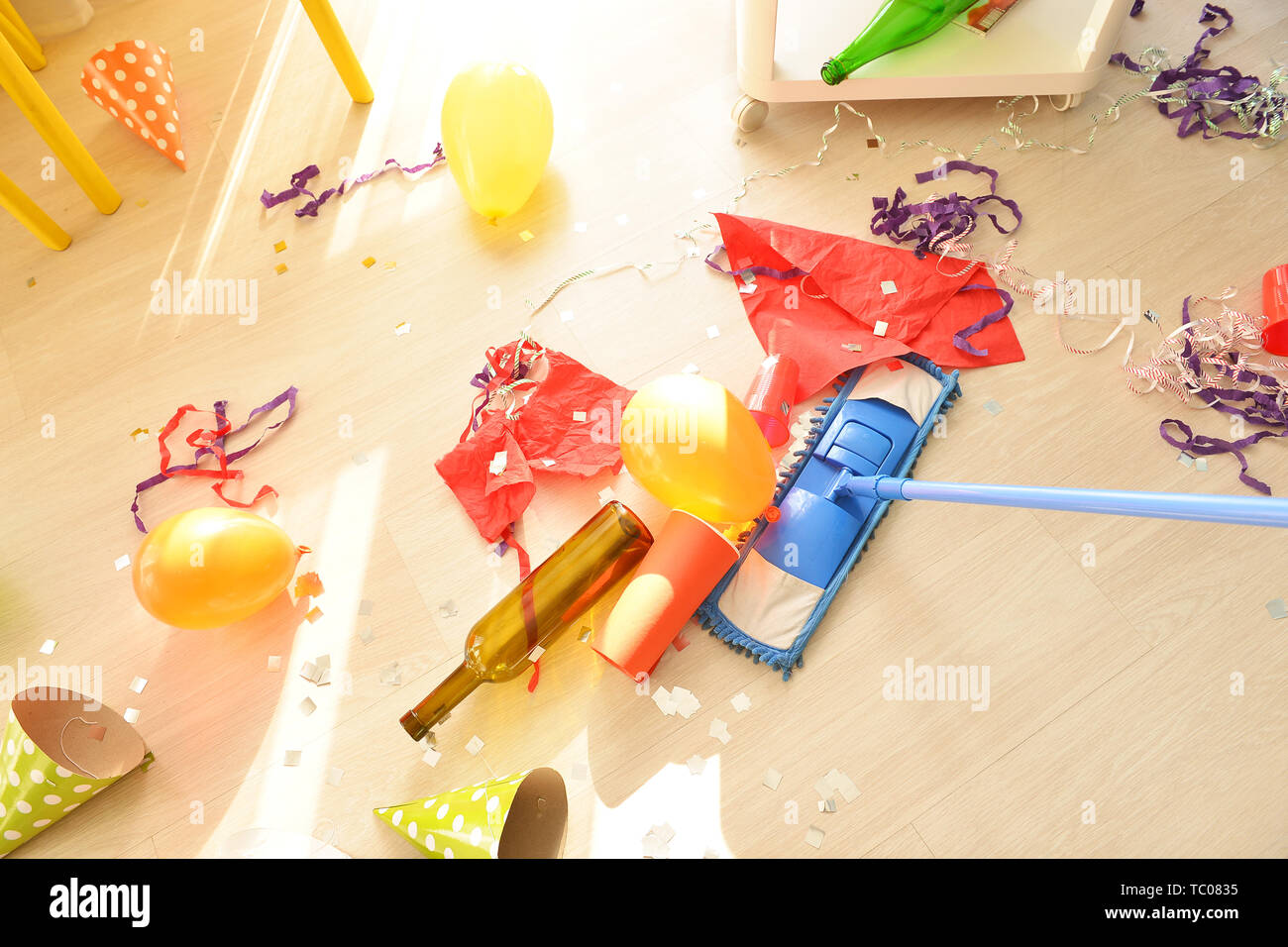 Cleaning of room in terrible mess after party Stock Photo - Alamy