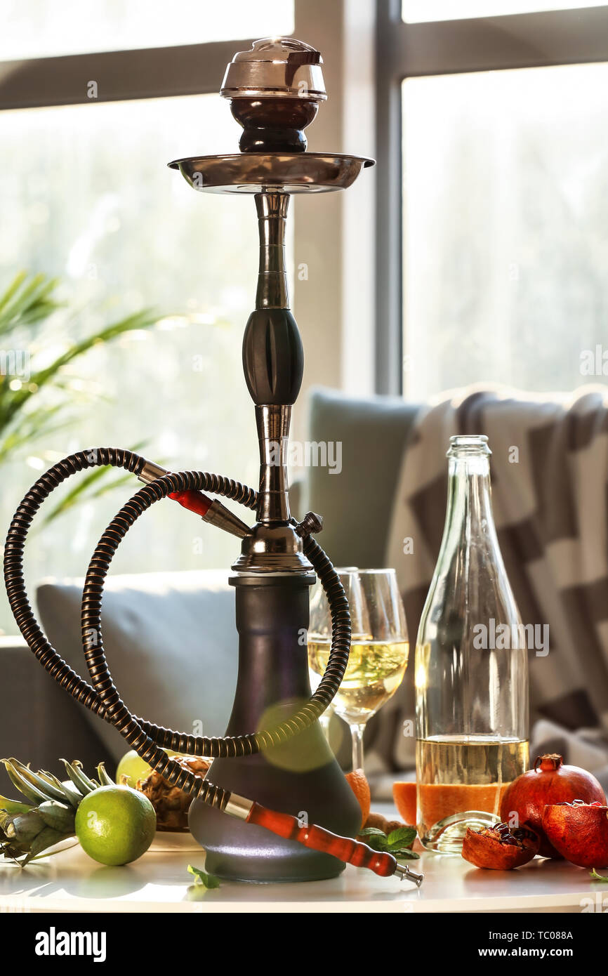 Hookah, fruits and alcohol on table in room Stock Photo - Alamy
