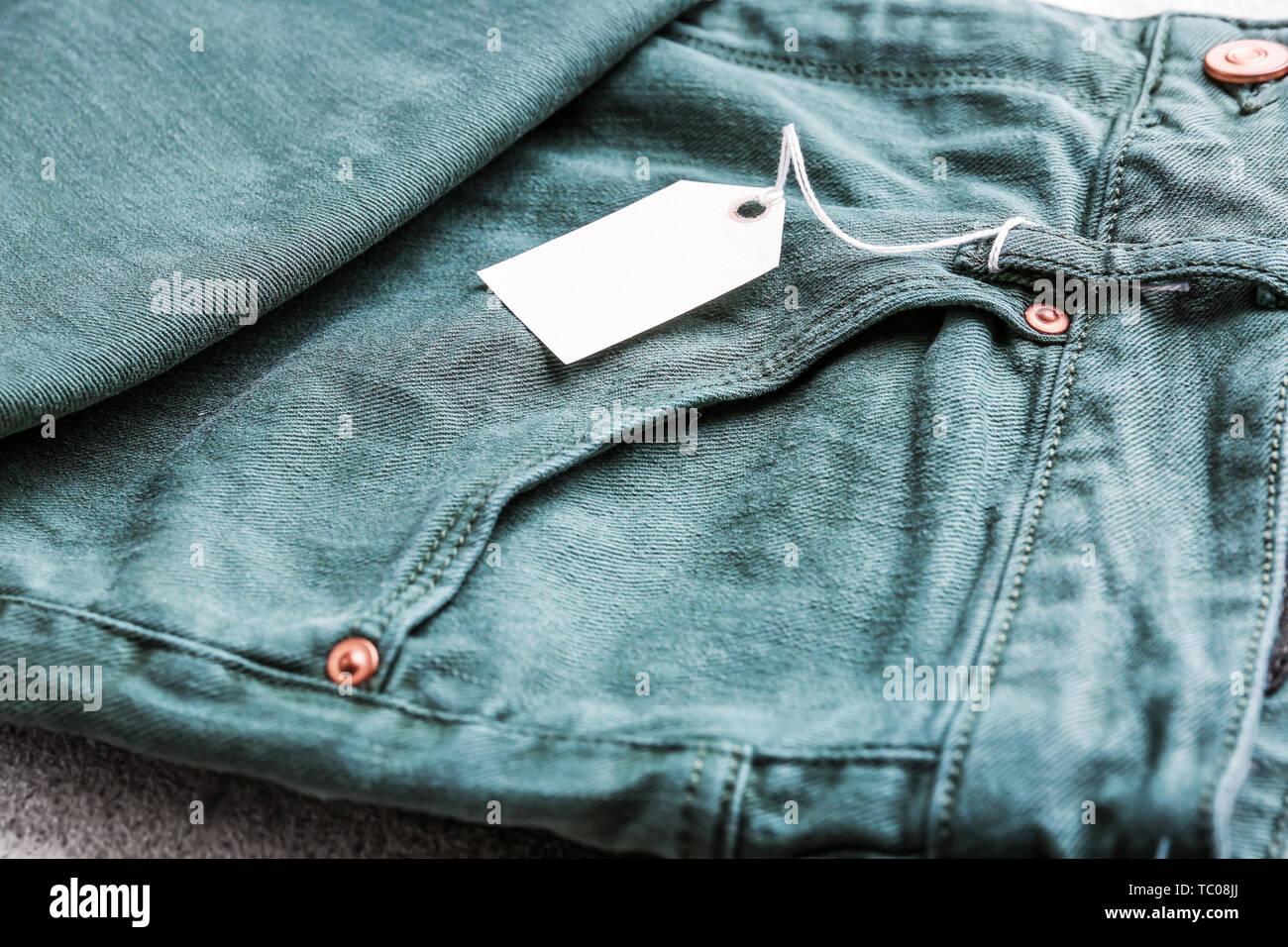 Stylish jeans with tag, closeup Stock Photo - Alamy