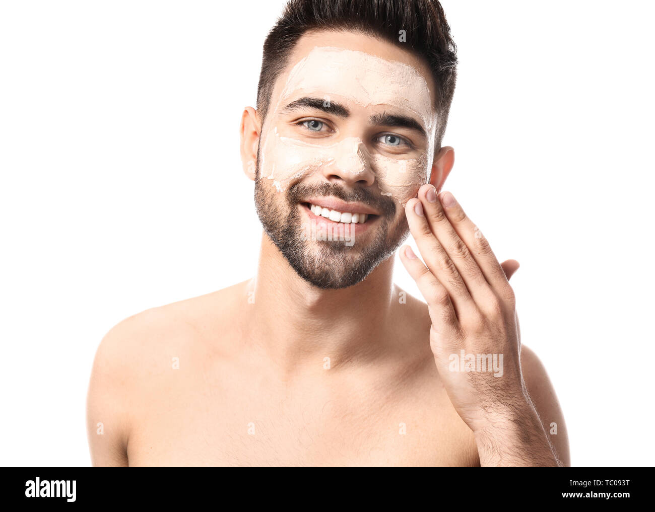 Handsome man with clay mask on his face against white background Stock ...