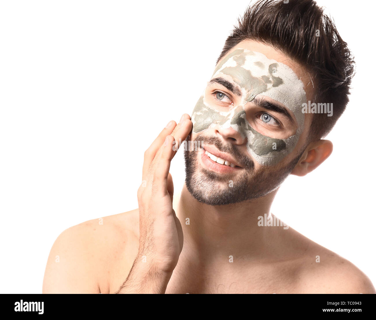 Handsome man with clay mask on his face against white background Stock ...