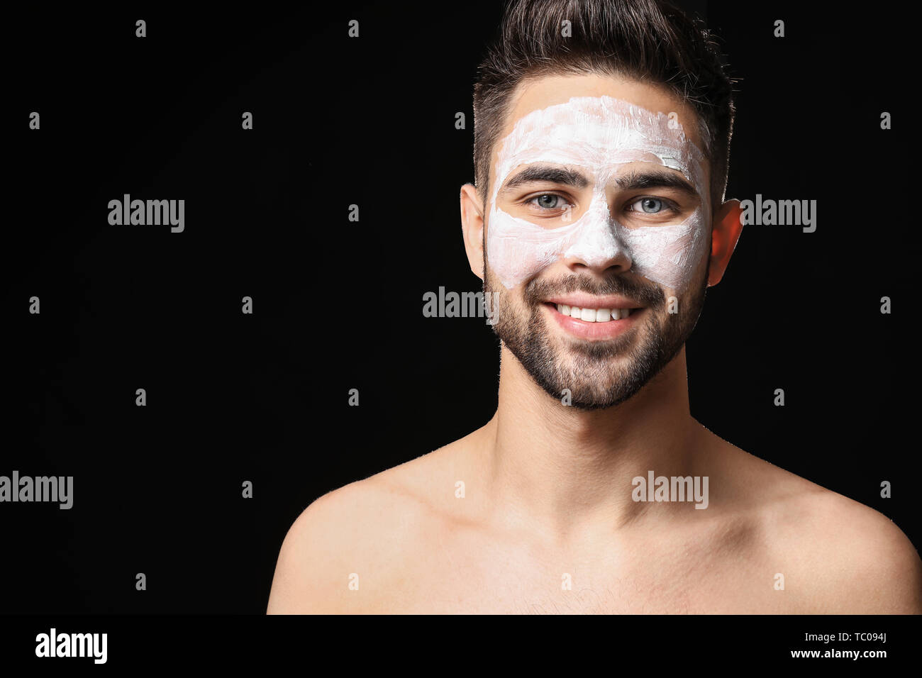 Handsome man with clay mask on his face against dark background Stock ...