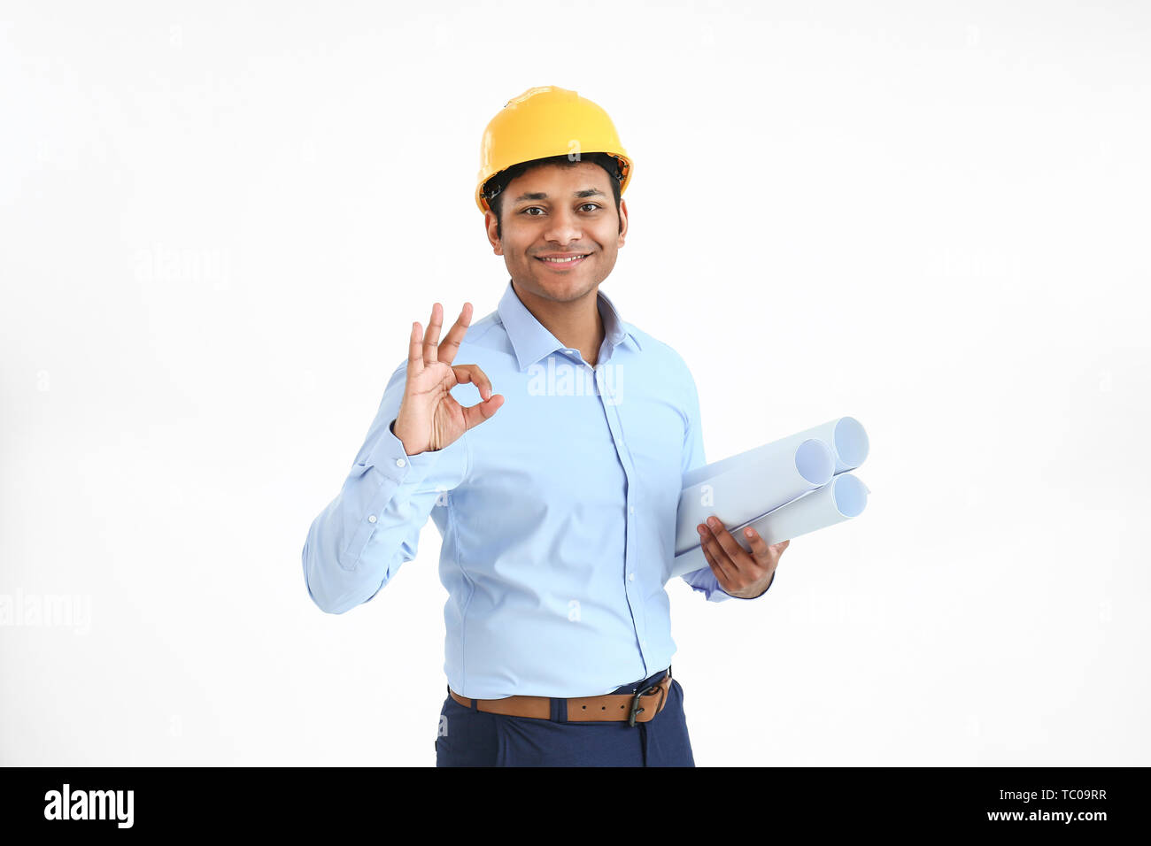 Handsome architect showing OK on white background Stock Photo - Alamy