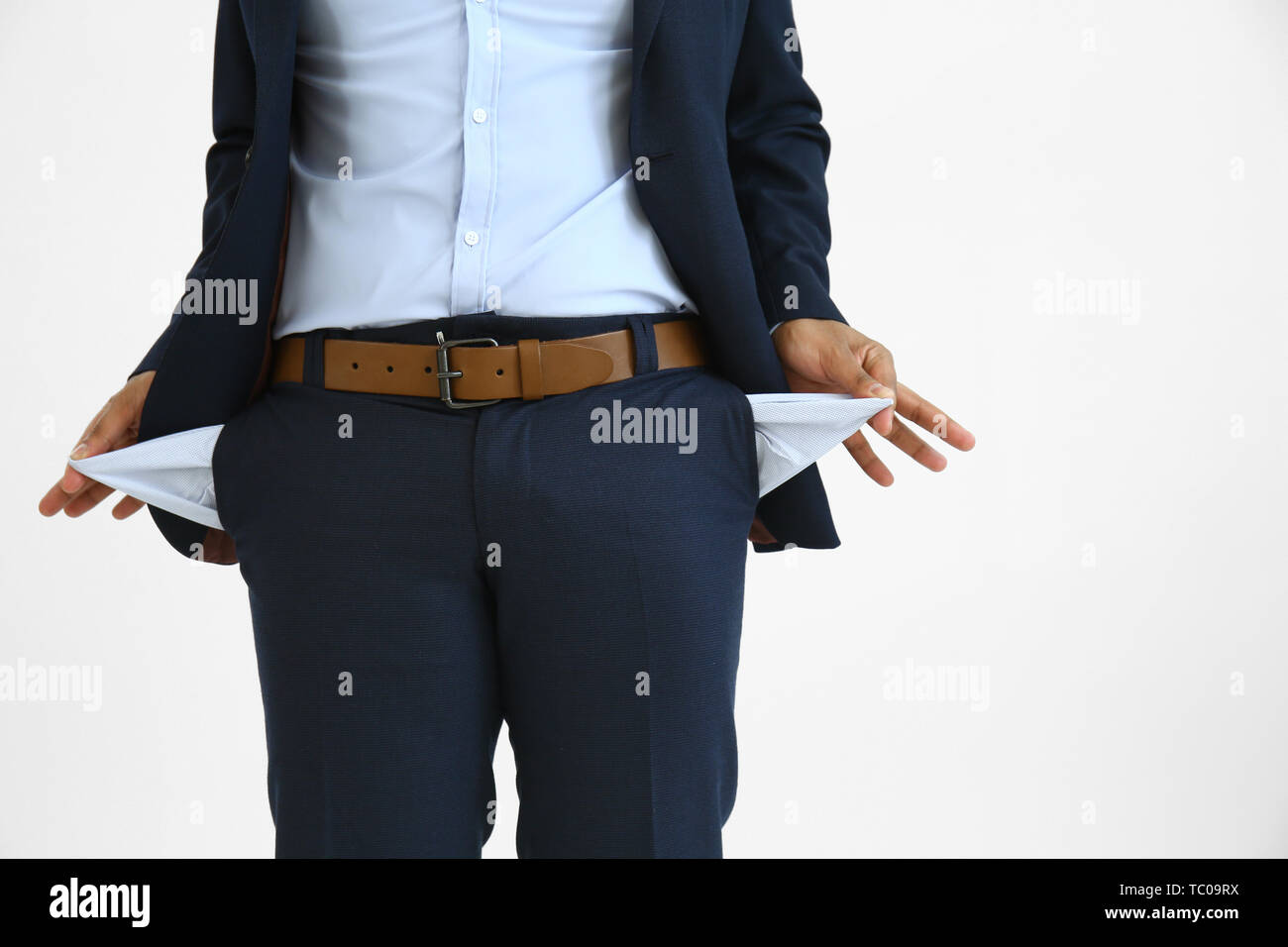Businessman with empty pockets on white background Stock Photo - Alamy