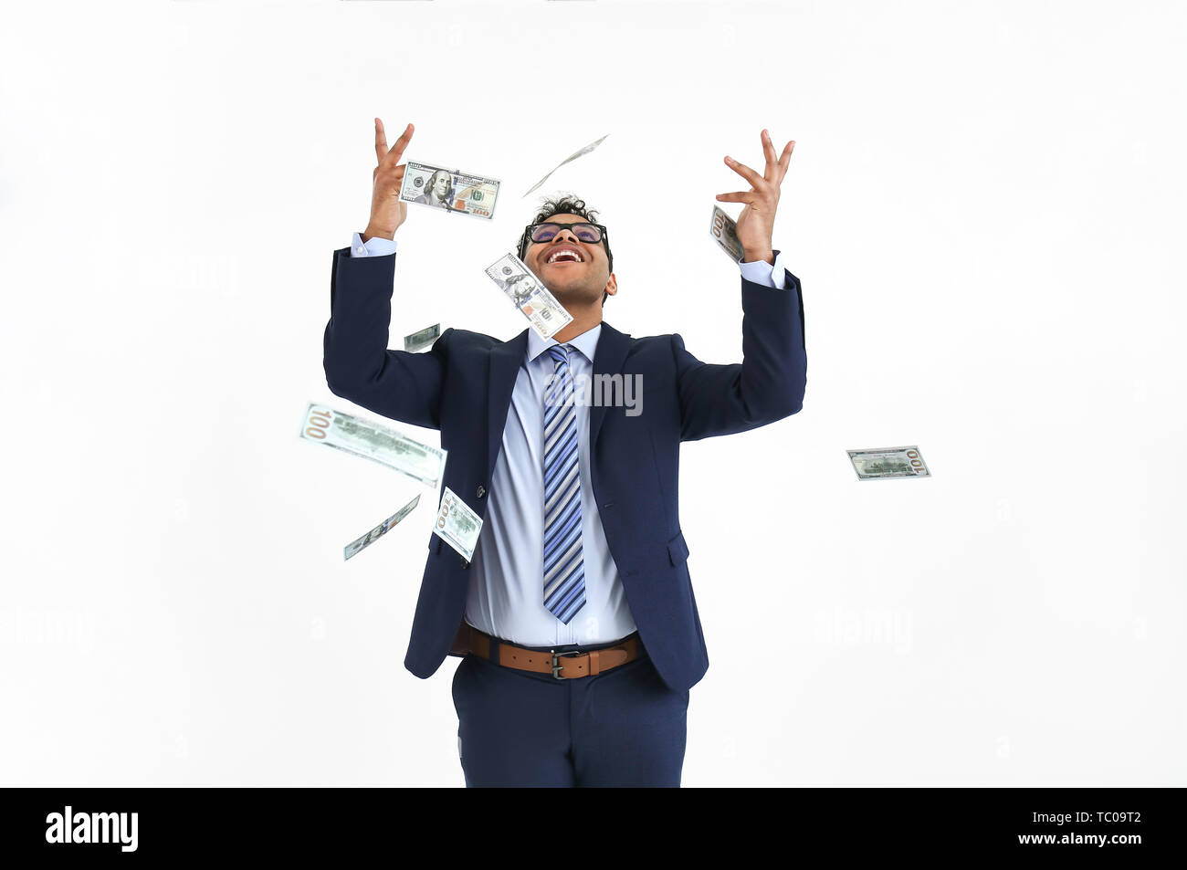 Happy businessman and falling dollar banknotes on white background ...