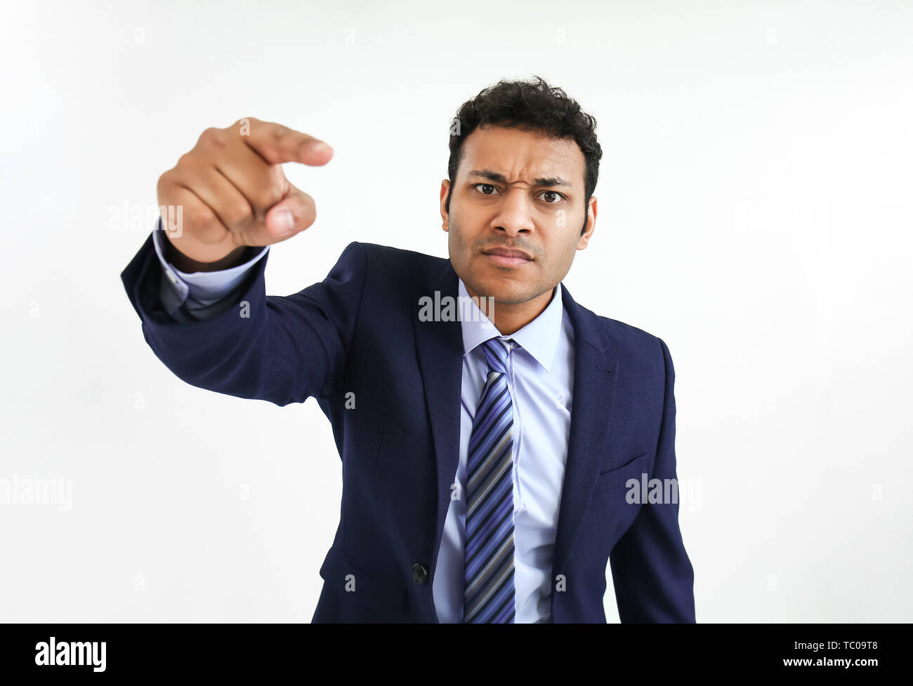 Handsome businessman pointing at viewer on white background Stock Photo ...