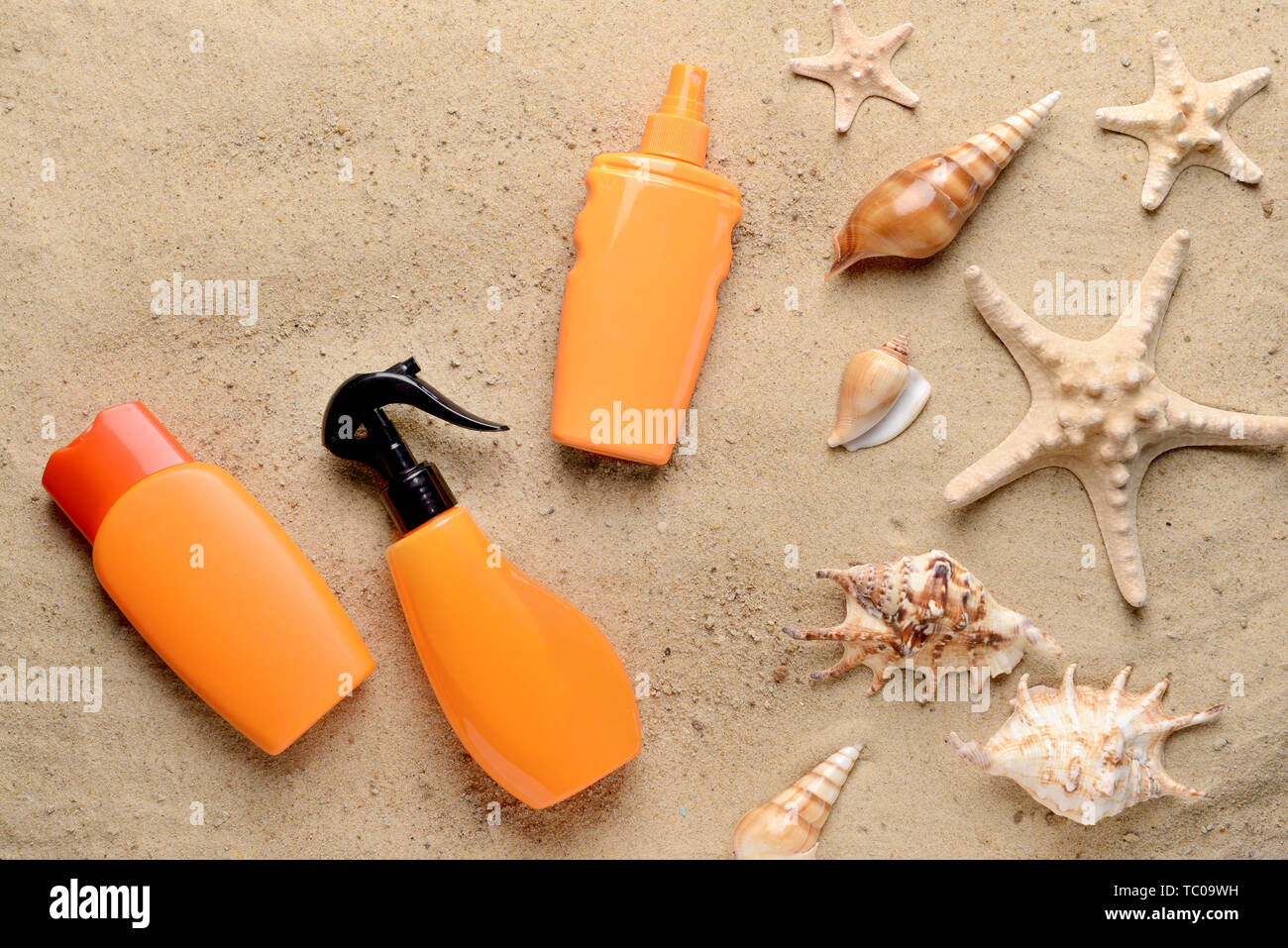 Bottles of sun protection cream and seashells on sand Stock Photo - Alamy