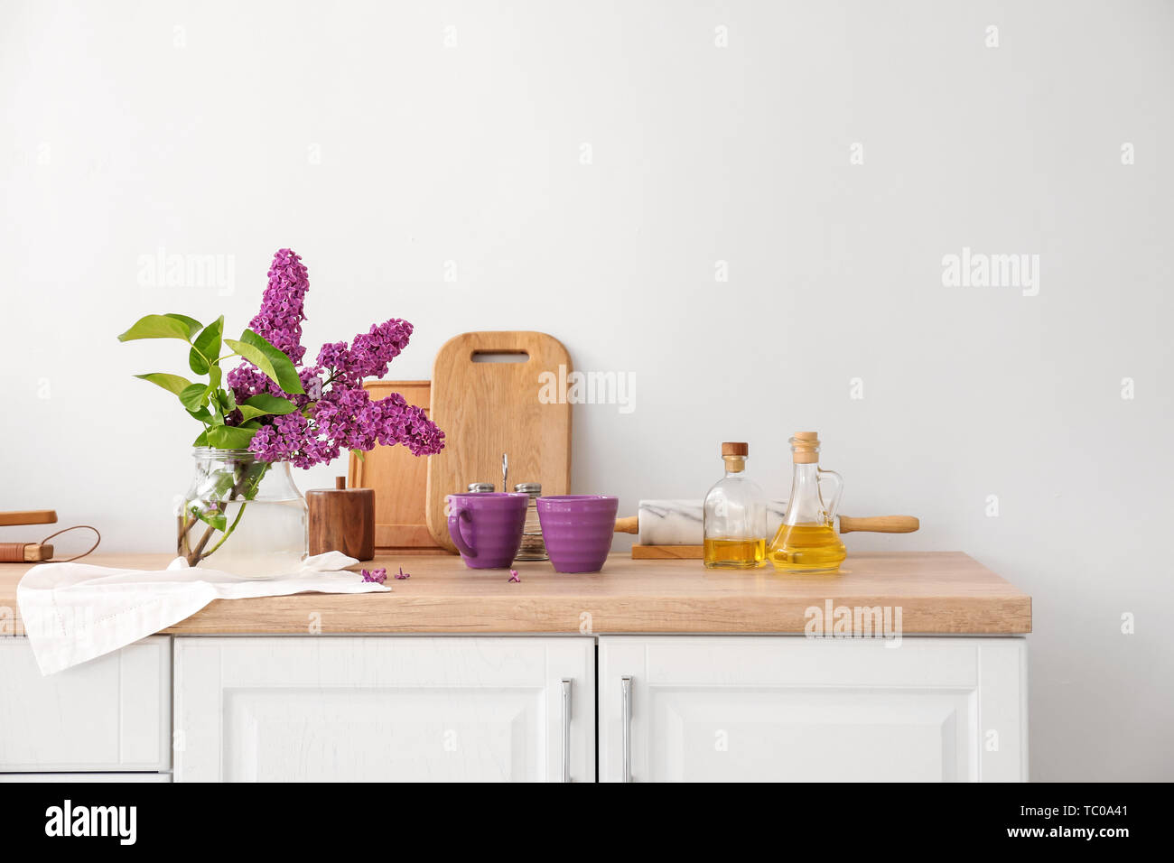 Beautiful lilac flowers on counter in kitchen Stock Photo - Alamy