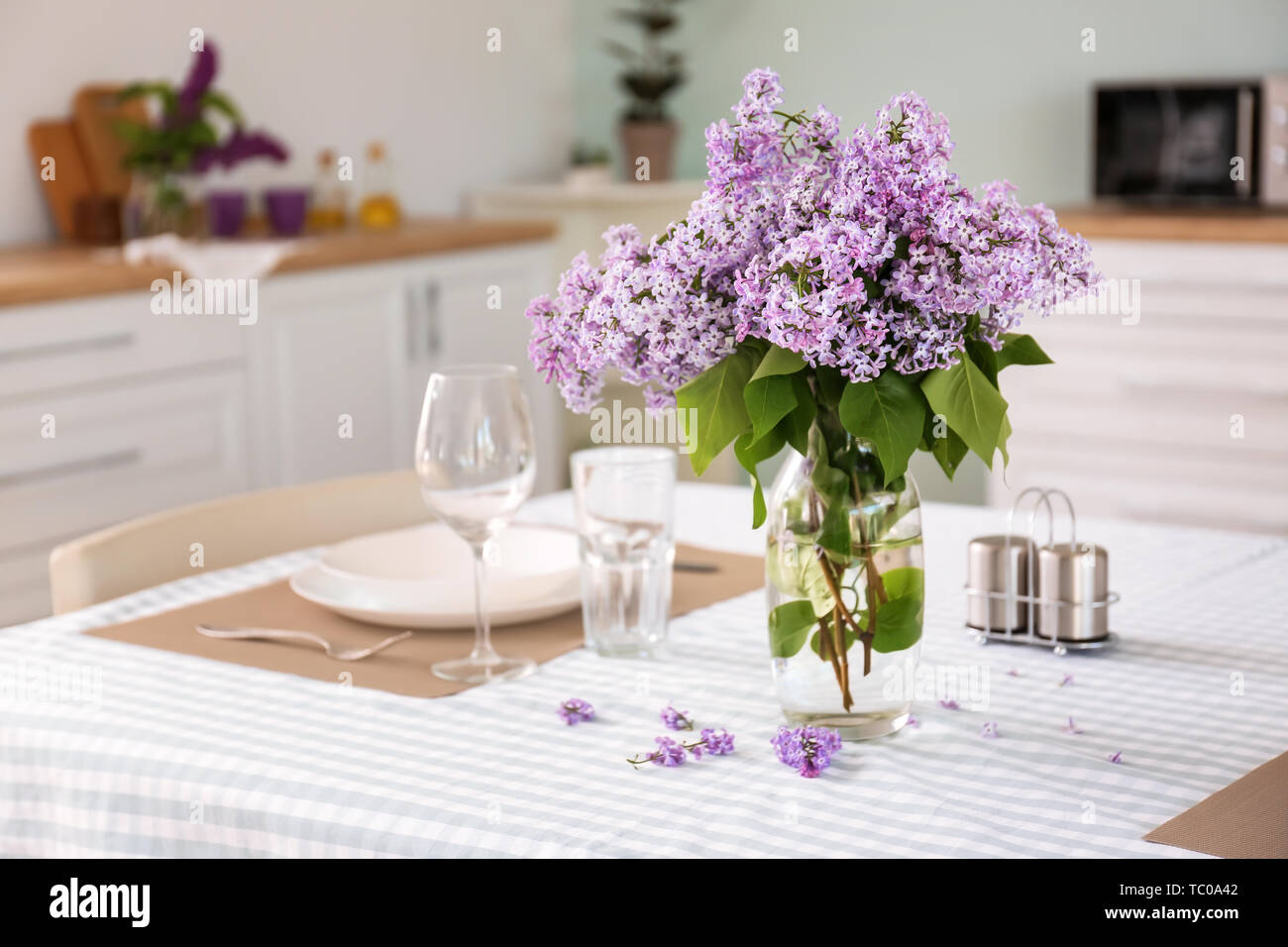 Beautiful lilac flowers on table in kitchen Stock Photo - Alamy