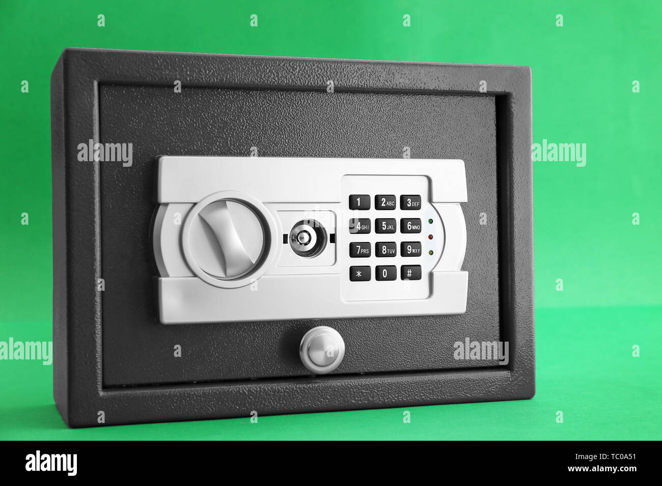 Modern safe on color background Stock Photo - Alamy