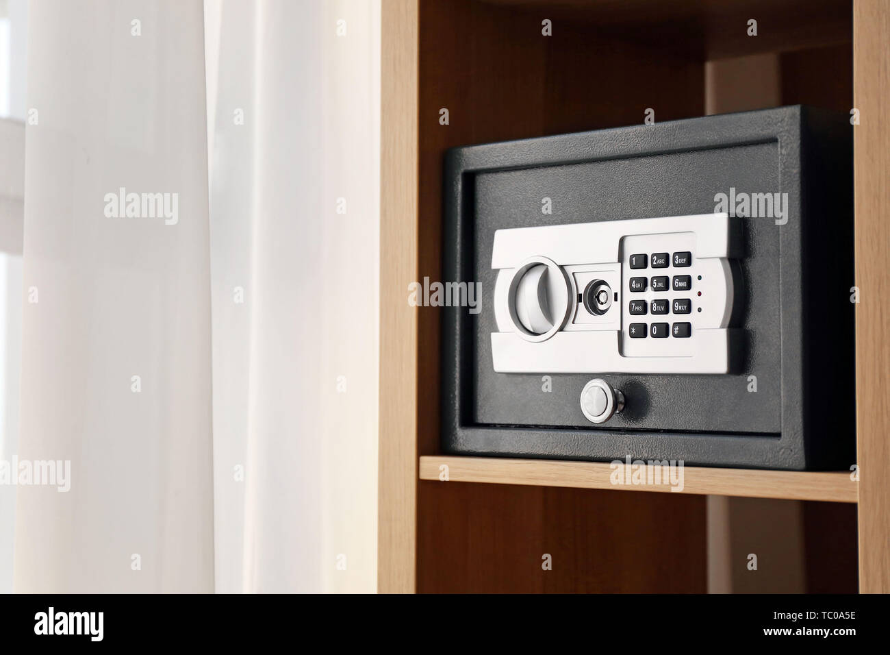 Small modern safe on shelf Stock Photo - Alamy