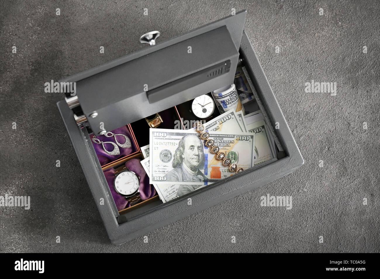 Small modern safe with valuables on grey background Stock Photo - Alamy