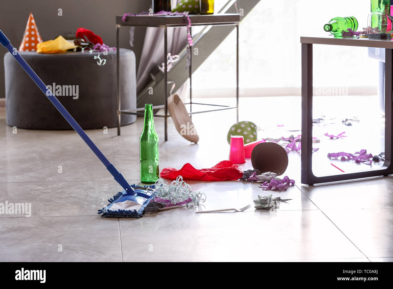 Cleaning of room in terrible mess after party Stock Photo - Alamy