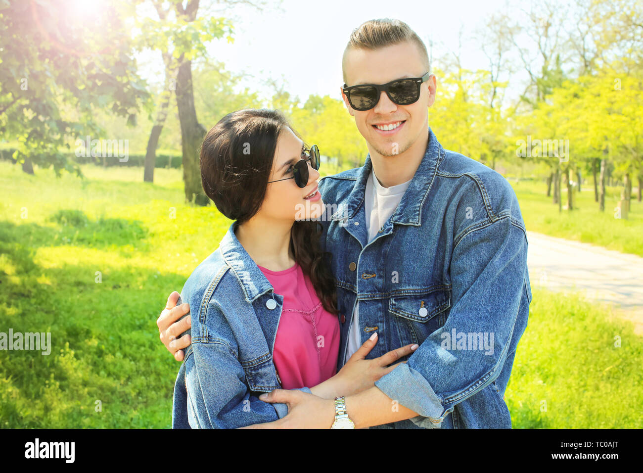 Adorable loving couple resting in park Stock Photo - Alamy
