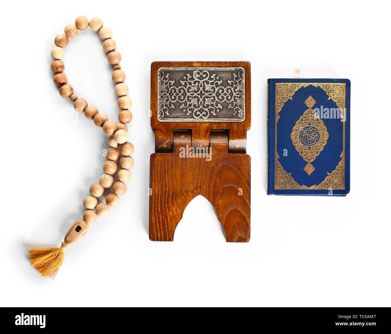 Muslim beads, rehal and Koran on white background Stock Photo - Alamy
