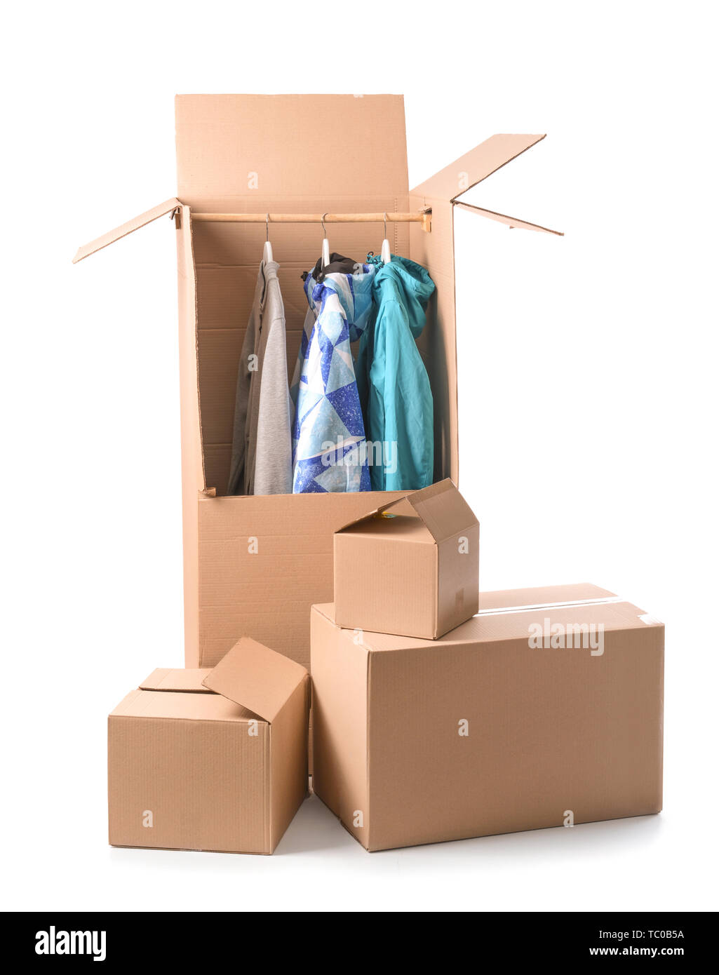 Wardrobe boxes with clothes on white background Stock Photo - Alamy