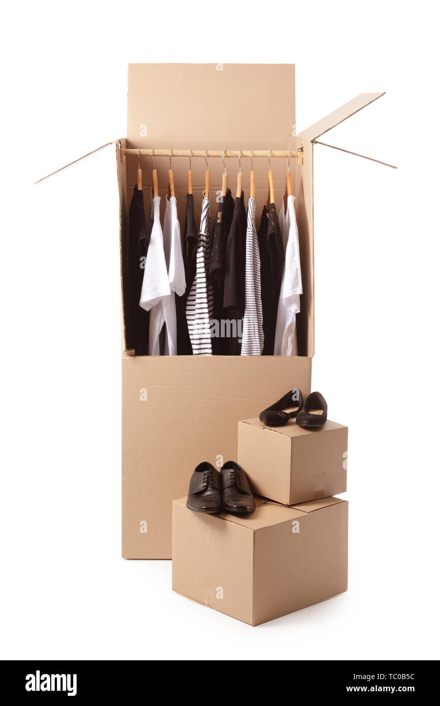 Wardrobe boxes with clothes on white background Stock Photo - Alamy