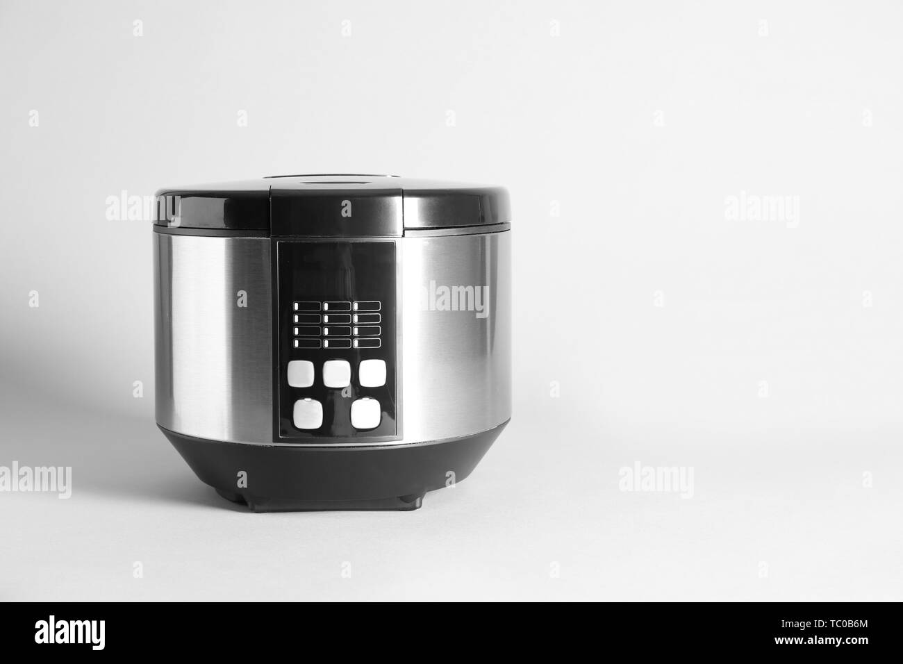 Modern multi cooker on light background Stock Photo - Alamy