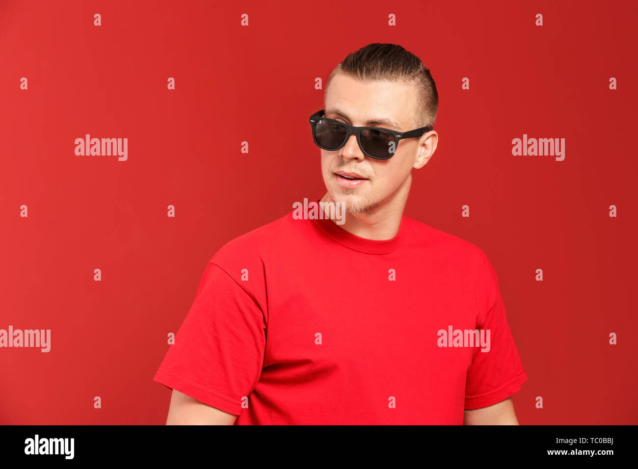 Cool young man on color background Stock Photo - Alamy