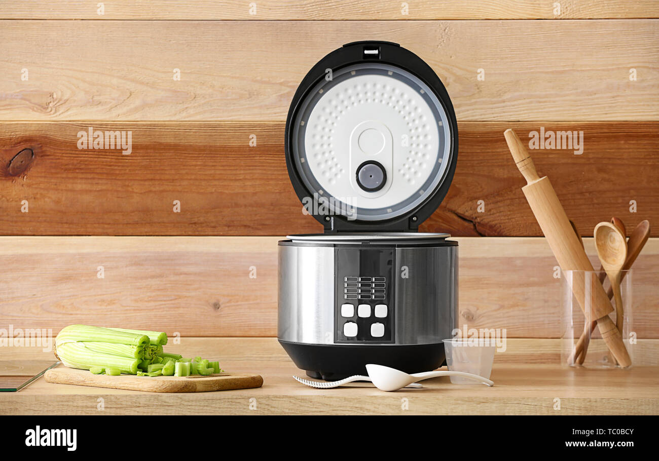 Modern multi cooker on kitchen table Stock Photo - Alamy