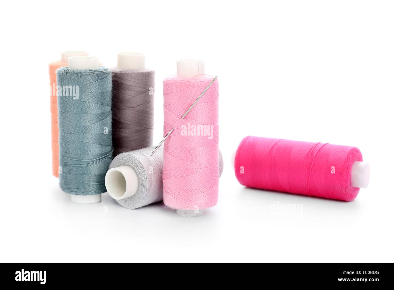 Colorful sewing threads on white background Stock Photo - Alamy