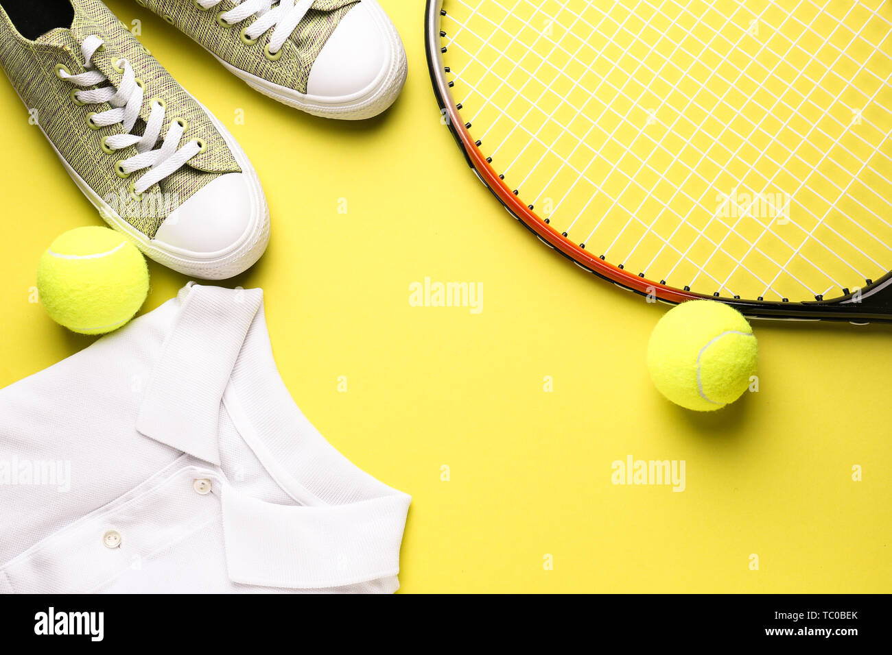 Tennis racket, shoes, clothes and balls on color background Stock Photo ...