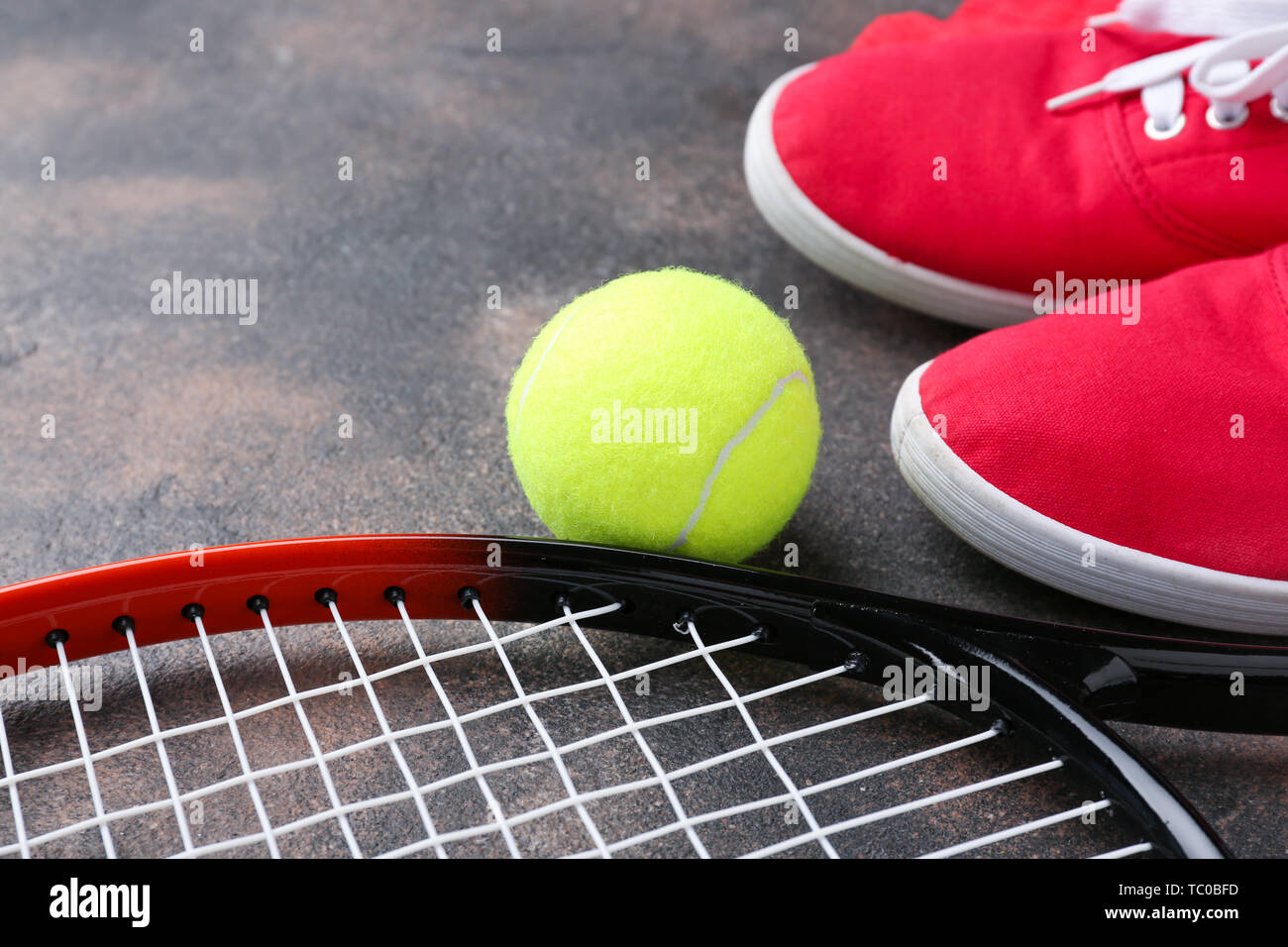 Tennis racket, shoes and ball on grunge background, closeup Stock Photo ...