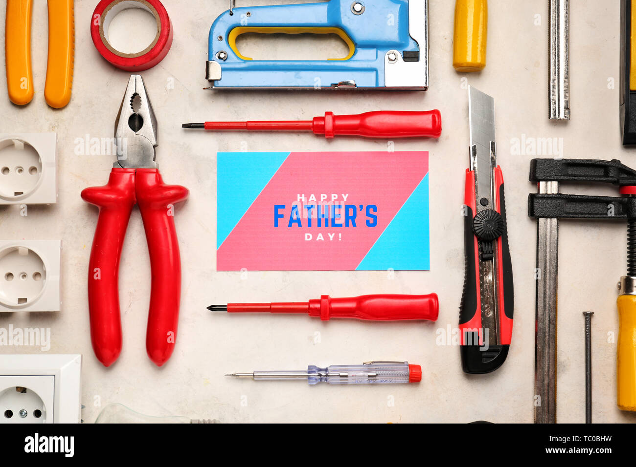 Different tools and card with text "Happy Father's Day" on light ...