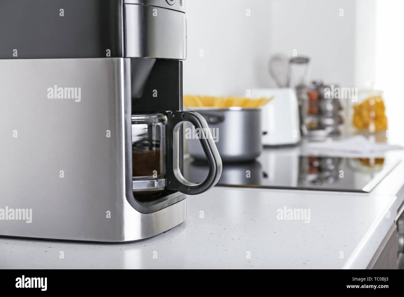 Modern coffee machine on kitchen table Stock Photo - Alamy