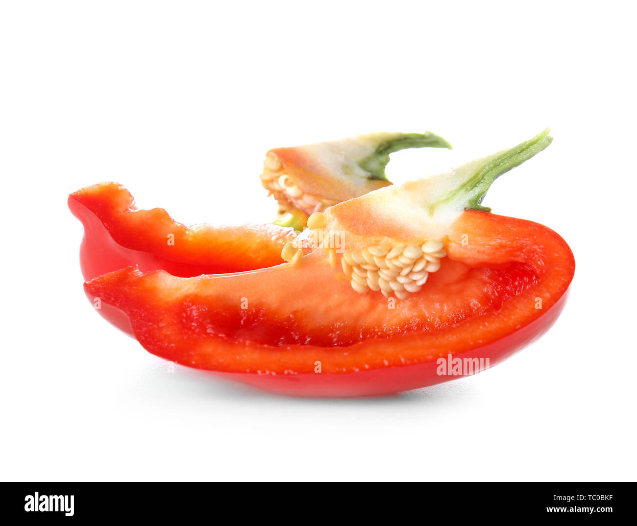 Cut ripe red pepper on white background Stock Photo - Alamy