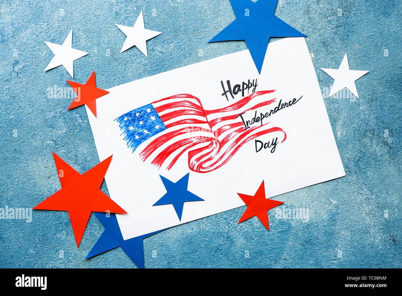 Paper sheet with drawing of USA flag and text HAPPY INDEPENDENCE DAY on ...