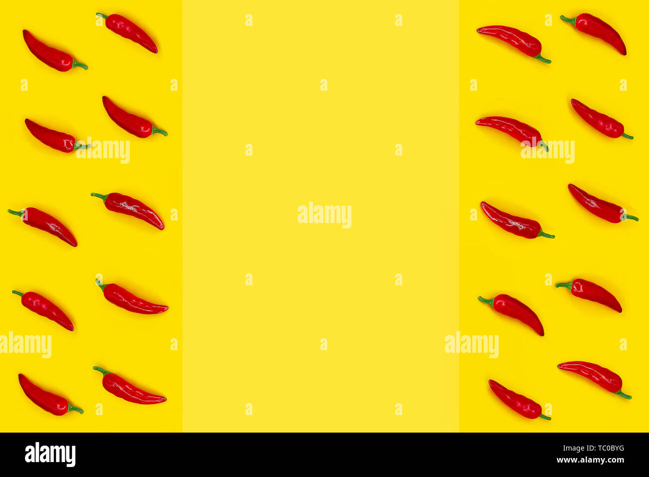 Red chili pepper frame on a yellow background with copy space ...