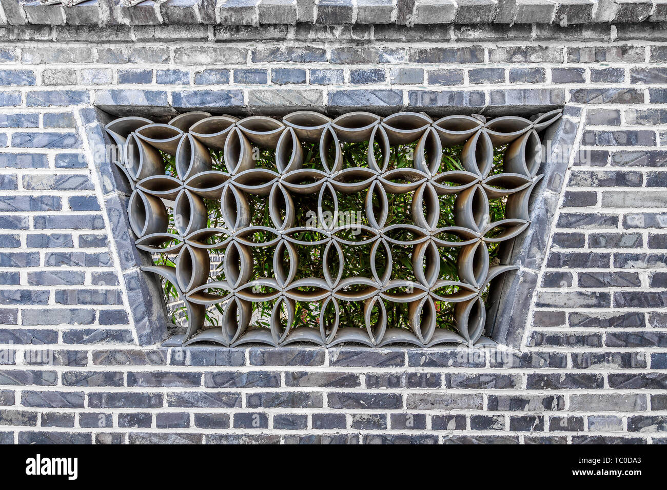 Garden wall tile hollowed-out window Stock Photo - Alamy
